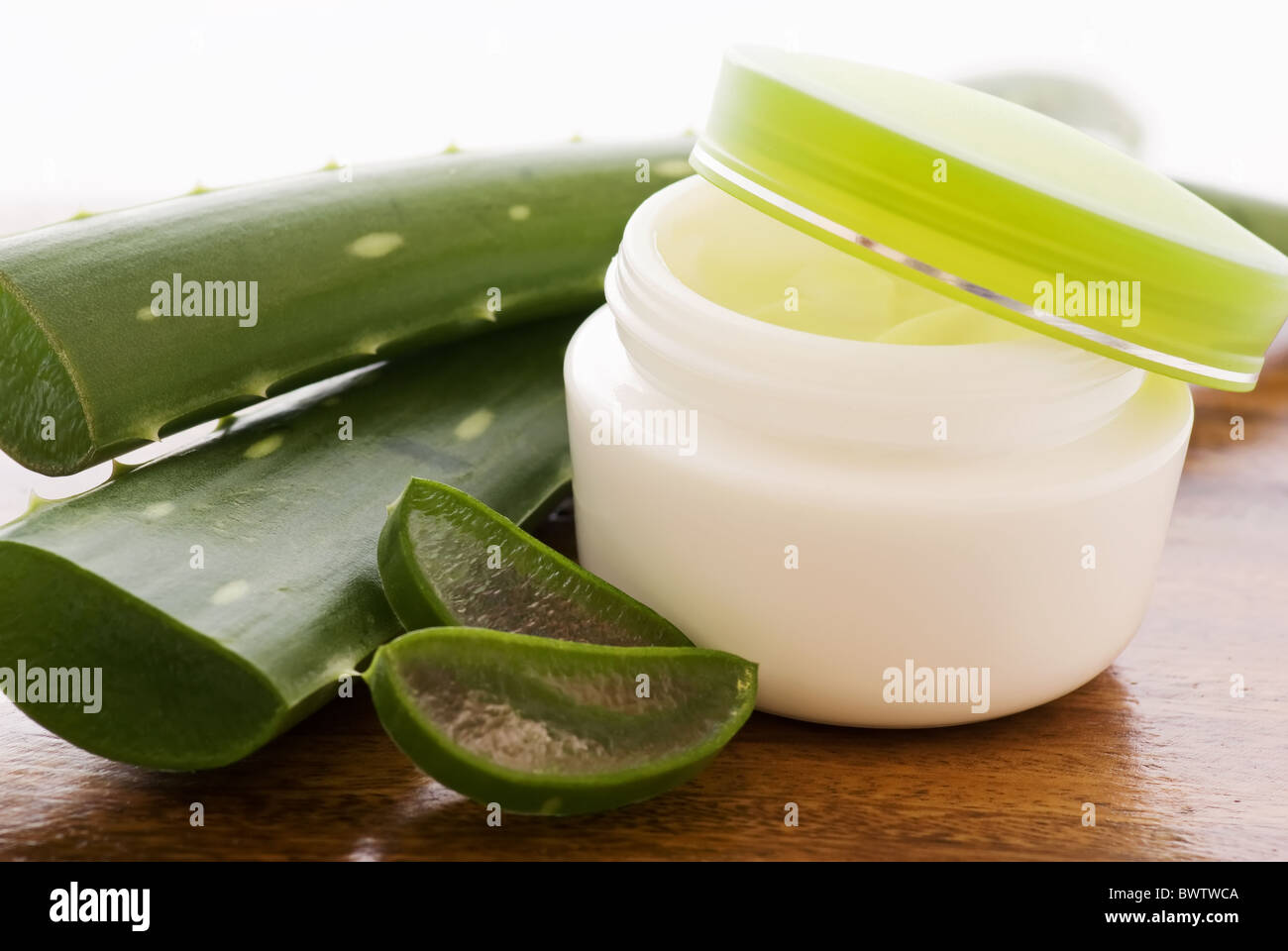 Aloe creme box with Aloe leaves and slices as closeup Stock Photo - Alamy