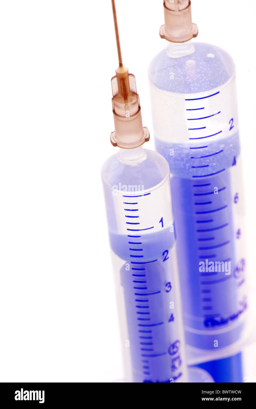 2 blue injections as closeup on white background Stock Photo - Alamy