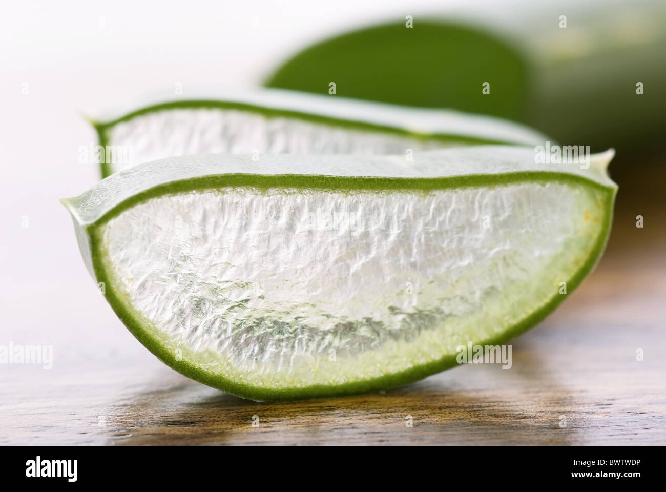 Aloe leaves with cut aloe slice as closeup on white background Stock ...