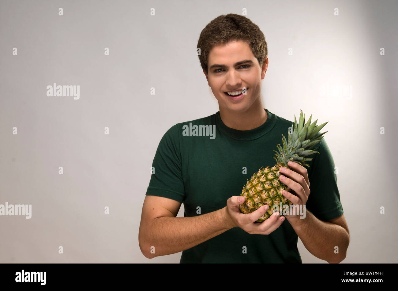 Man holding a pineapple Stock Photo - Alamy
