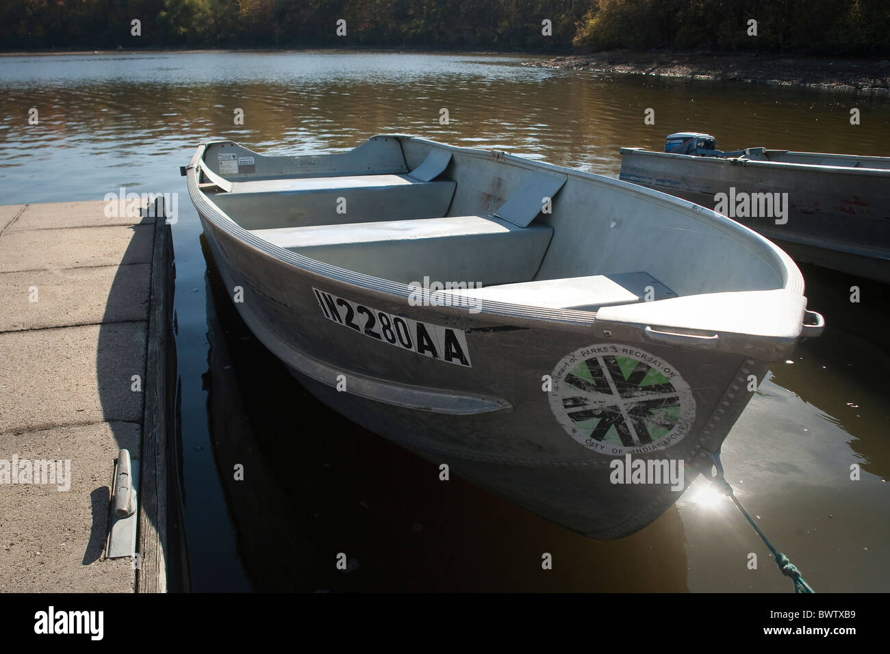 row boat tied up at dock in lake Stock Photo - Alamy