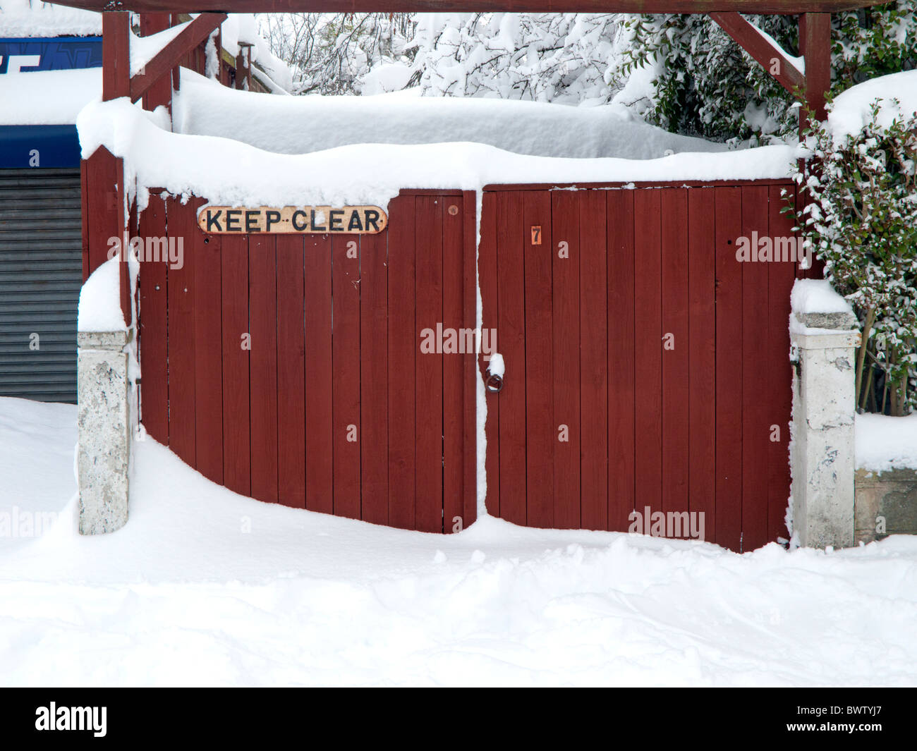 Gates in heavy snow with Keep Clear sign Stock Photo - Alamy
