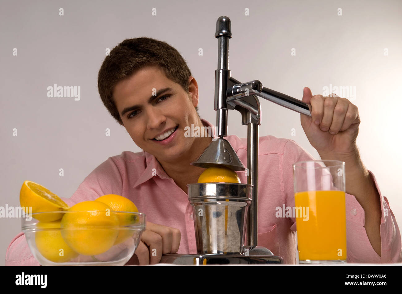 Man making orange juice Stock Photo - Alamy