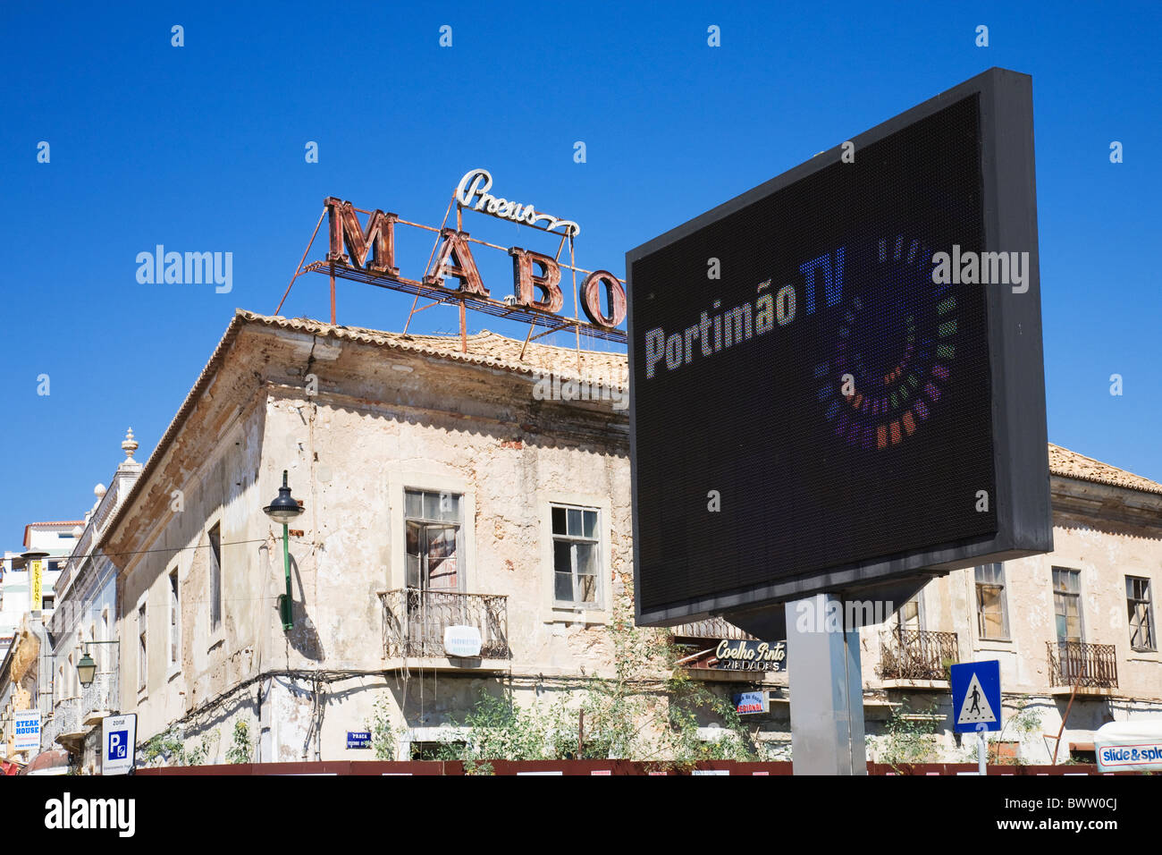 A large outdoor TV screen contrasting with an old building in Portimao ...