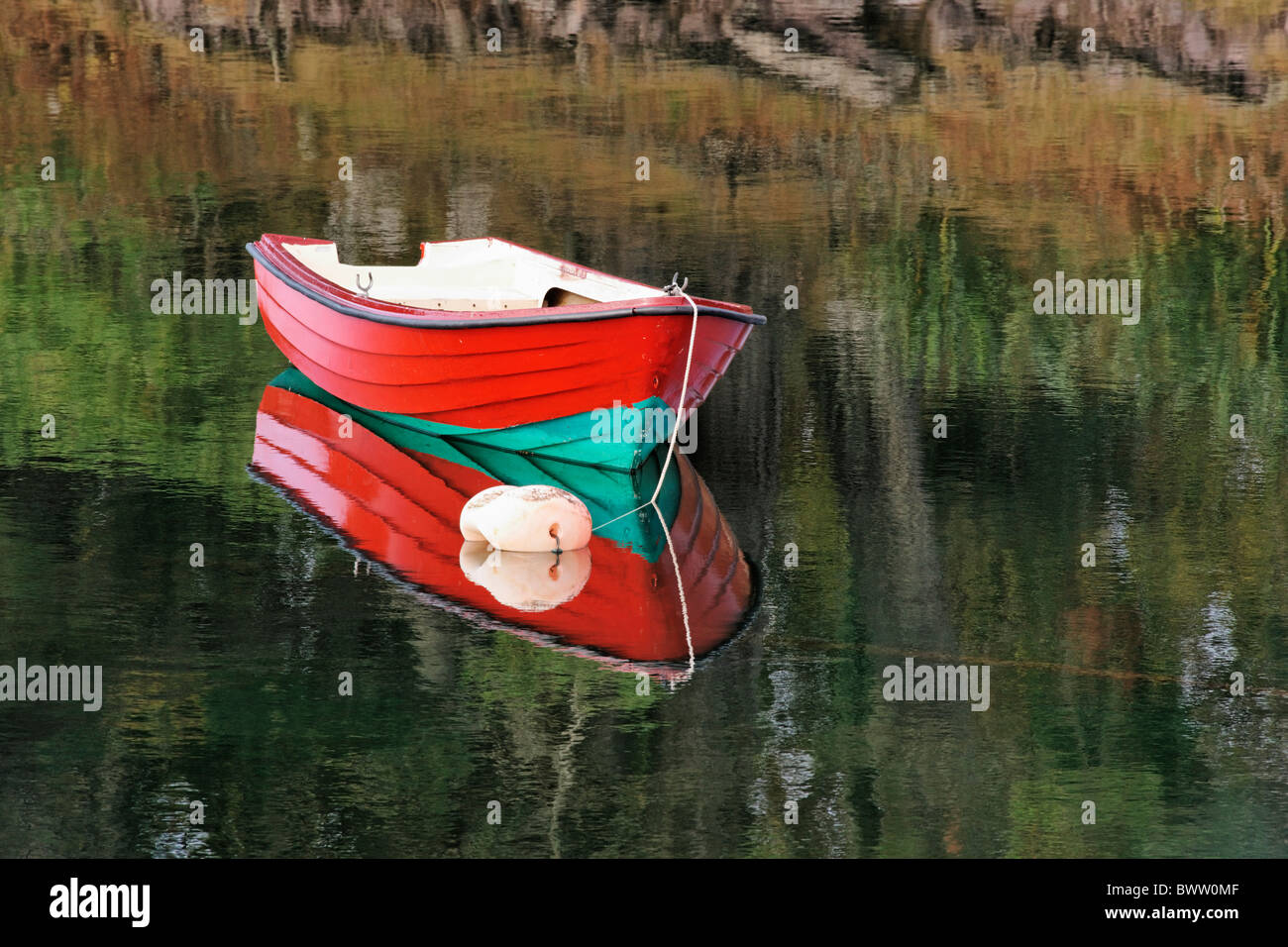 Red rowing boat moored in Cove Harbour, Castle Cove, County Kerry ...