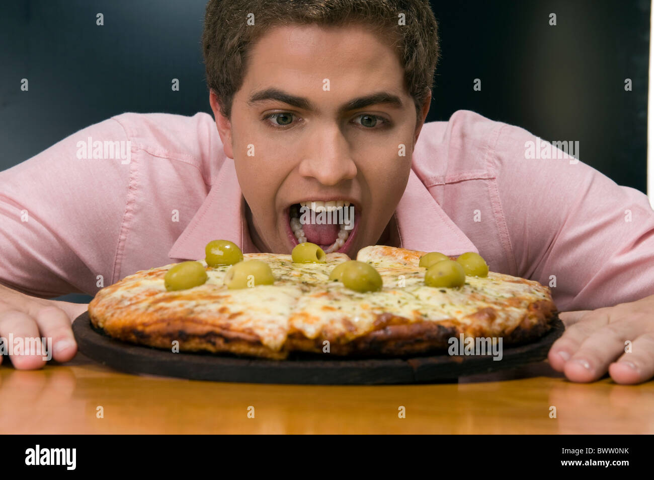 Portrait of a man with a pizza Stock Photo - Alamy