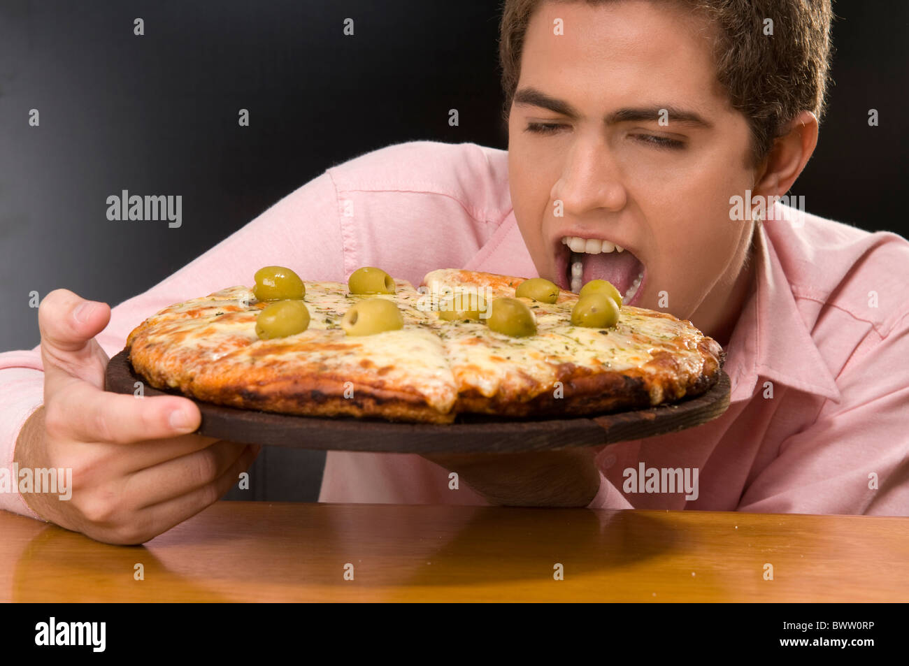 Portrait of a man with a pizza Stock Photo - Alamy