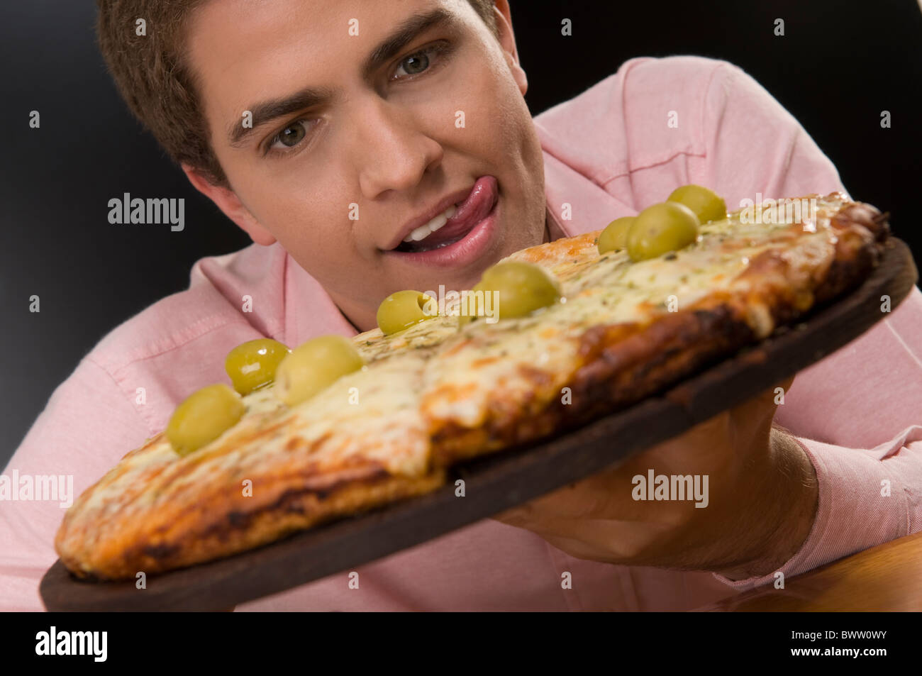 Handsome black man holding pizza hi-res stock photography and images ...
