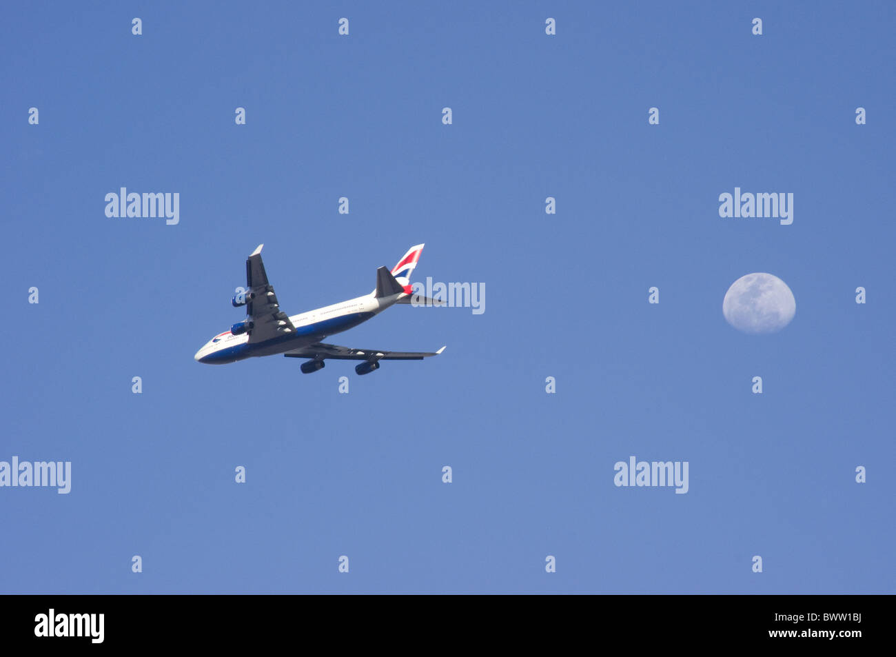 Airplane (British Airways) flying over Mexico city with the moon in the ...