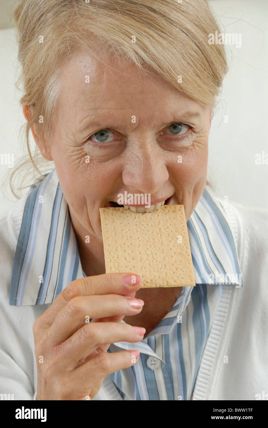 Woman Senior Seniors Mature Portrait biting Eating Eat Crispbread Bread ...