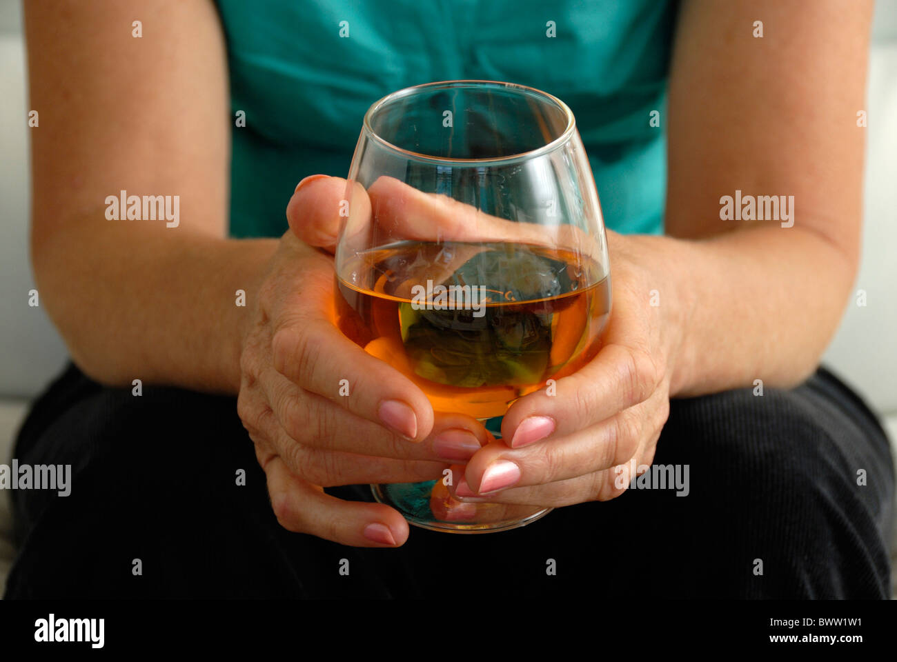 Alcoholic alcohol female hand hands glass Holding hold cognac brandy ...