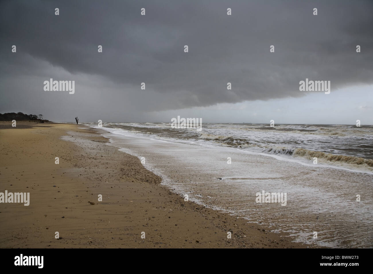 Storm over coastline with waves washing over Stock Photo - Alamy