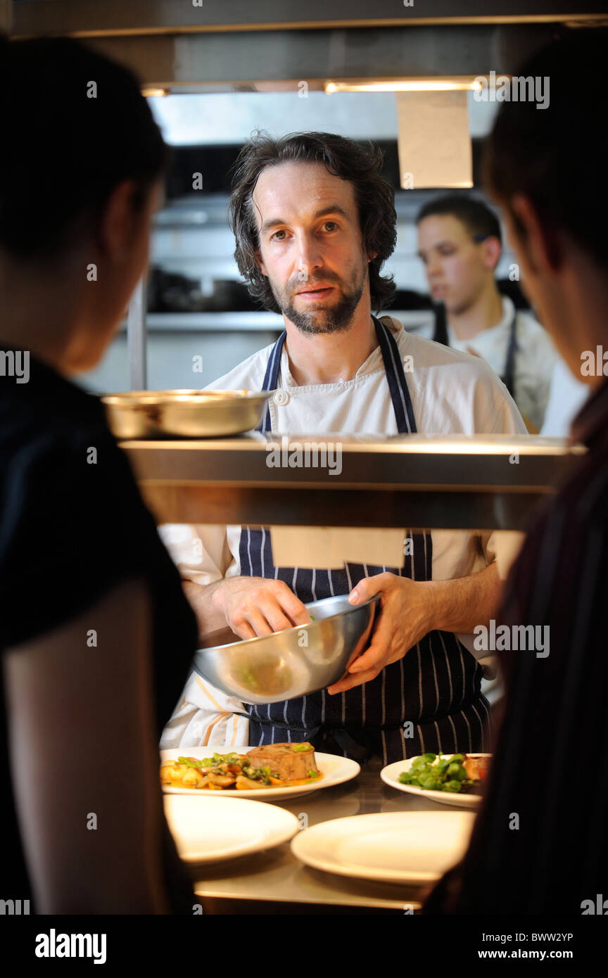 Head Chef Stephen Terry applies finishing touches to meals going out to ...