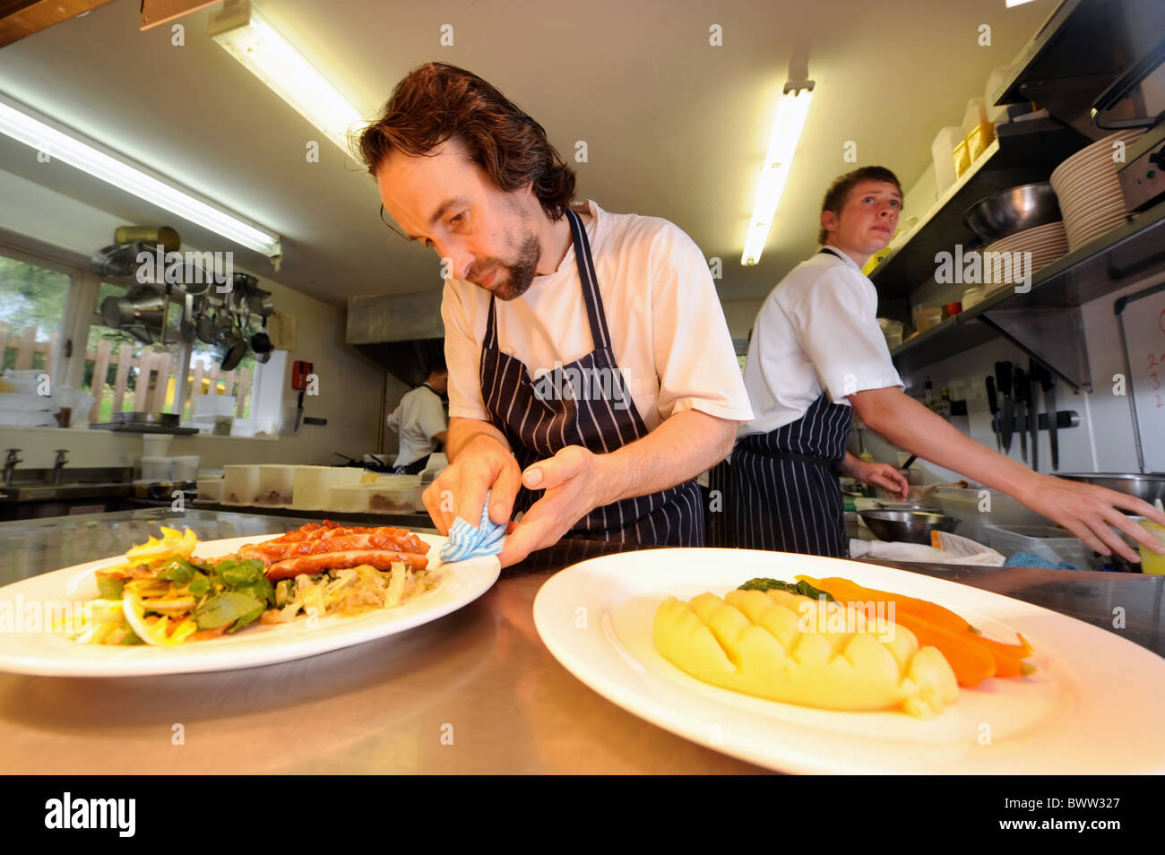 Head Chef Stephen Terry applies finishing touches to meals going out to ...