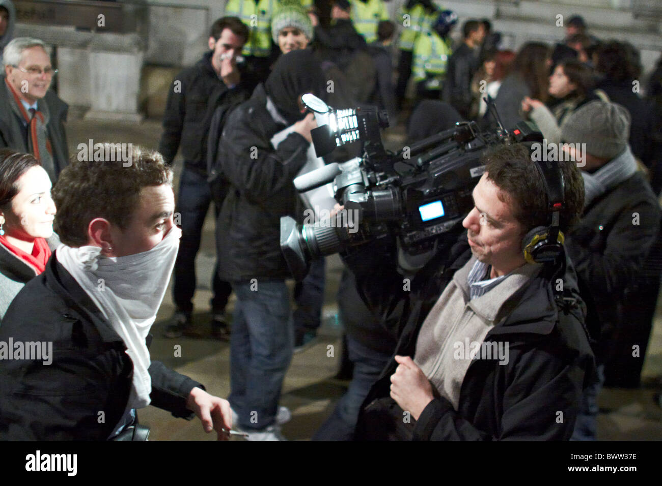 LONDON, UK. Masked protester gives an interview during a student ...