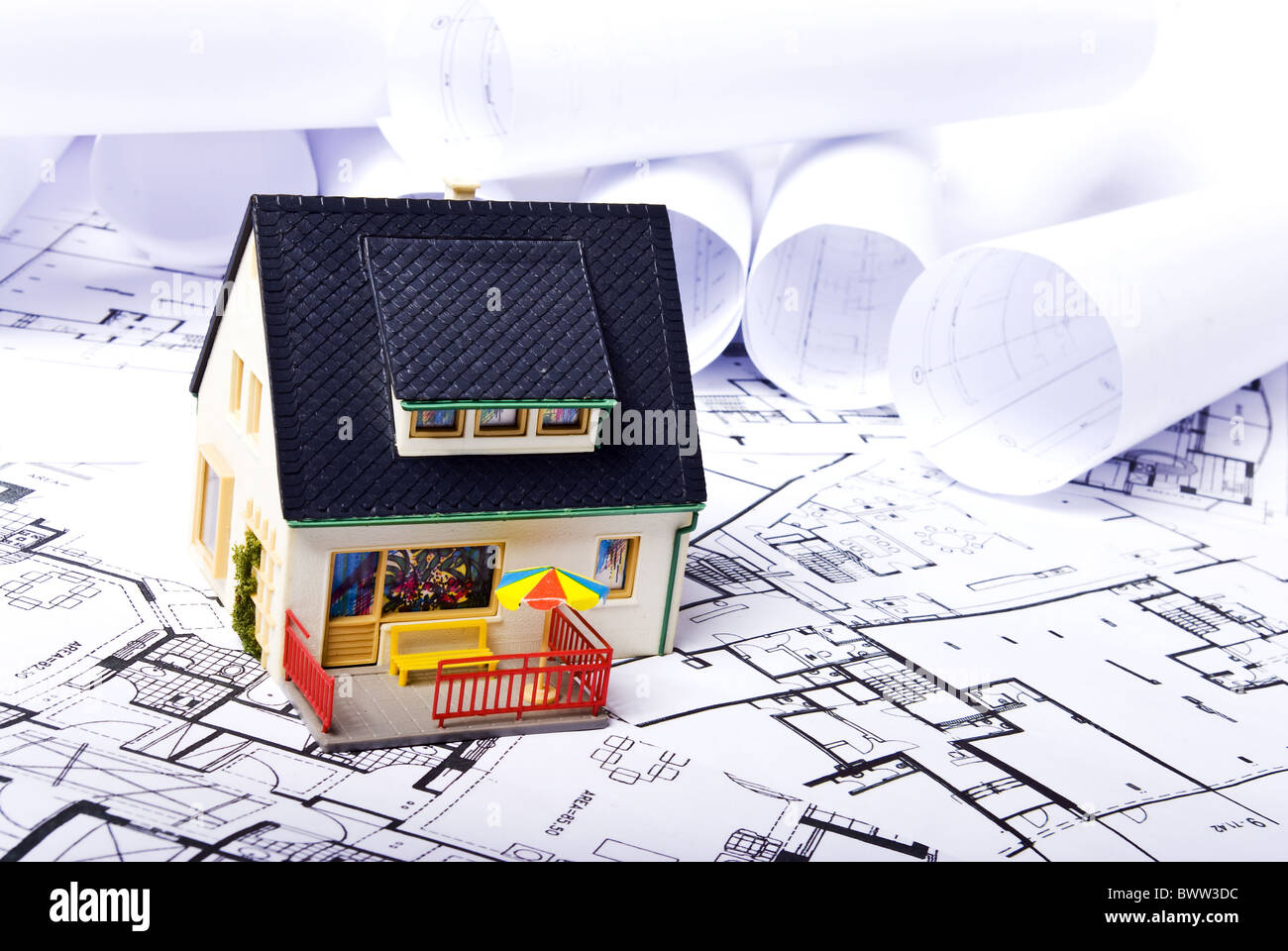 model house on plans background Stock Photo - Alamy