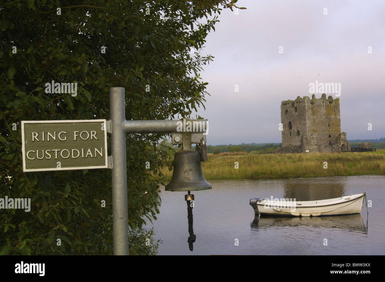 'Ring for Custodian' sign, bell, castle ruins and visitors ferry boat ...