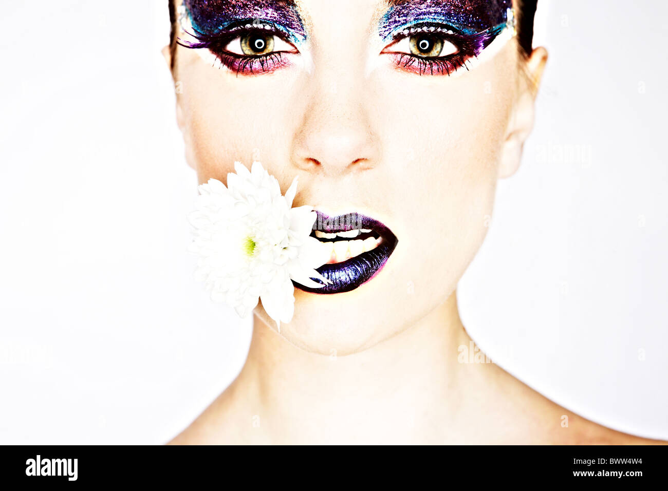 Female studio portrait flower in mouth intense high contrast work Stock ...