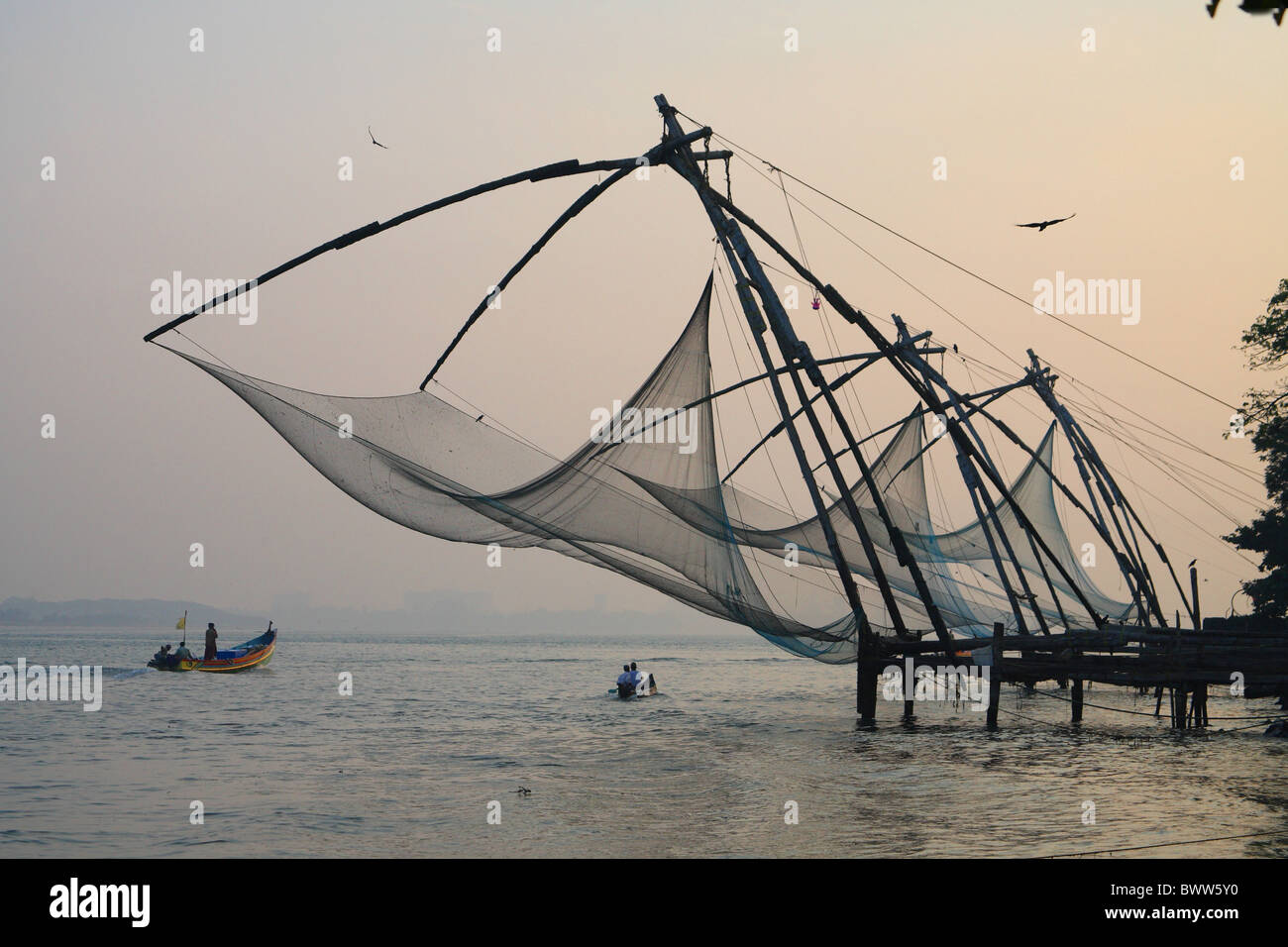 Chinese' fishing traps sunrise Cochin Kerala Stock Photo - Alamy