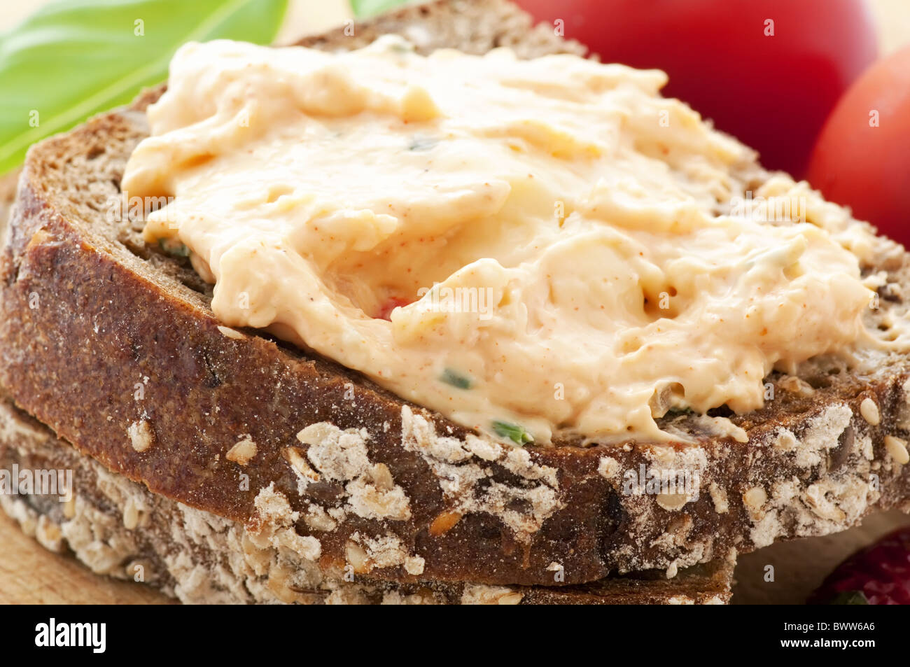 Cheese spread on farmhouse bread as closeup Stock Photo - Alamy
