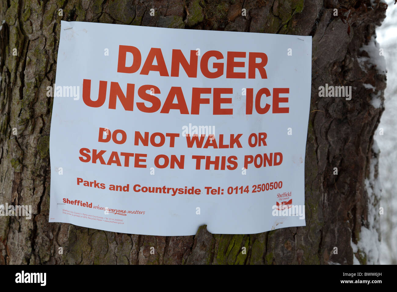 Danger unsafe ice sign by wire mill dam in Sheffield in winter Stock ...