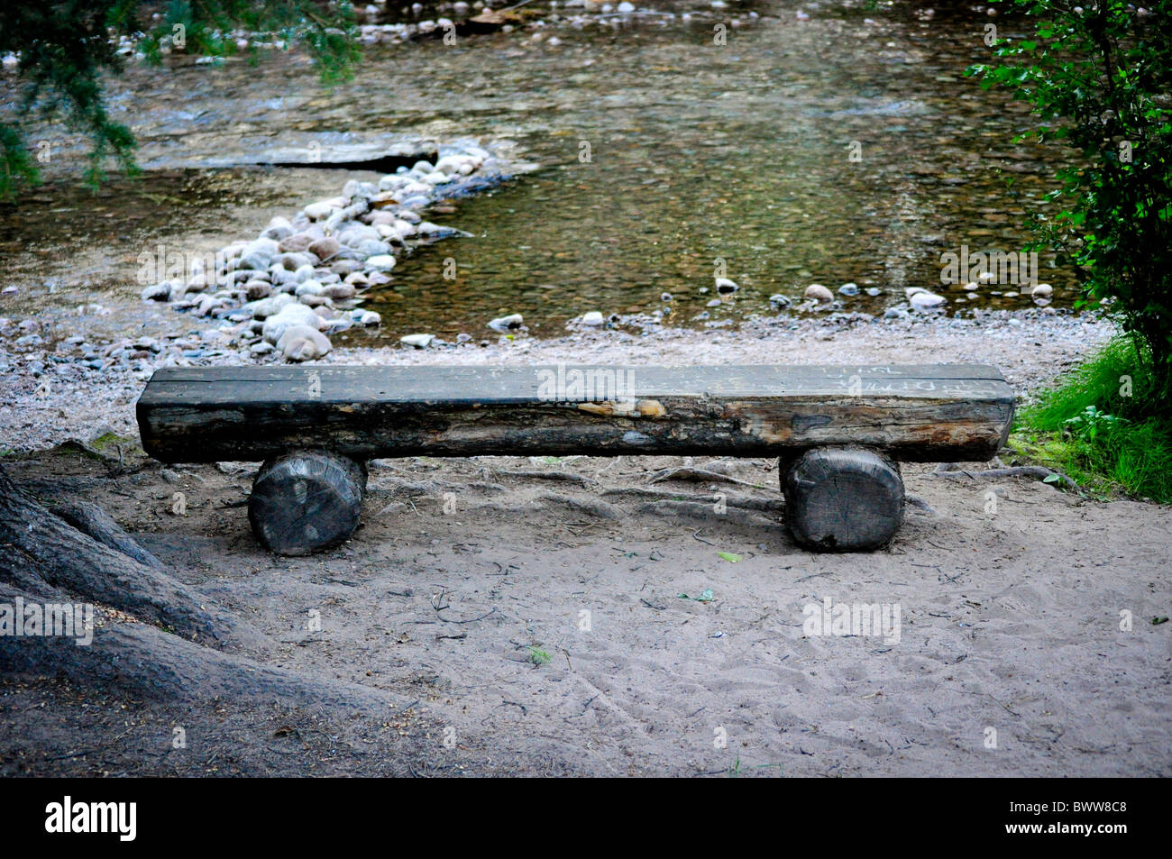 natural wooden bench by mountain stream Stock Photo - Alamy
