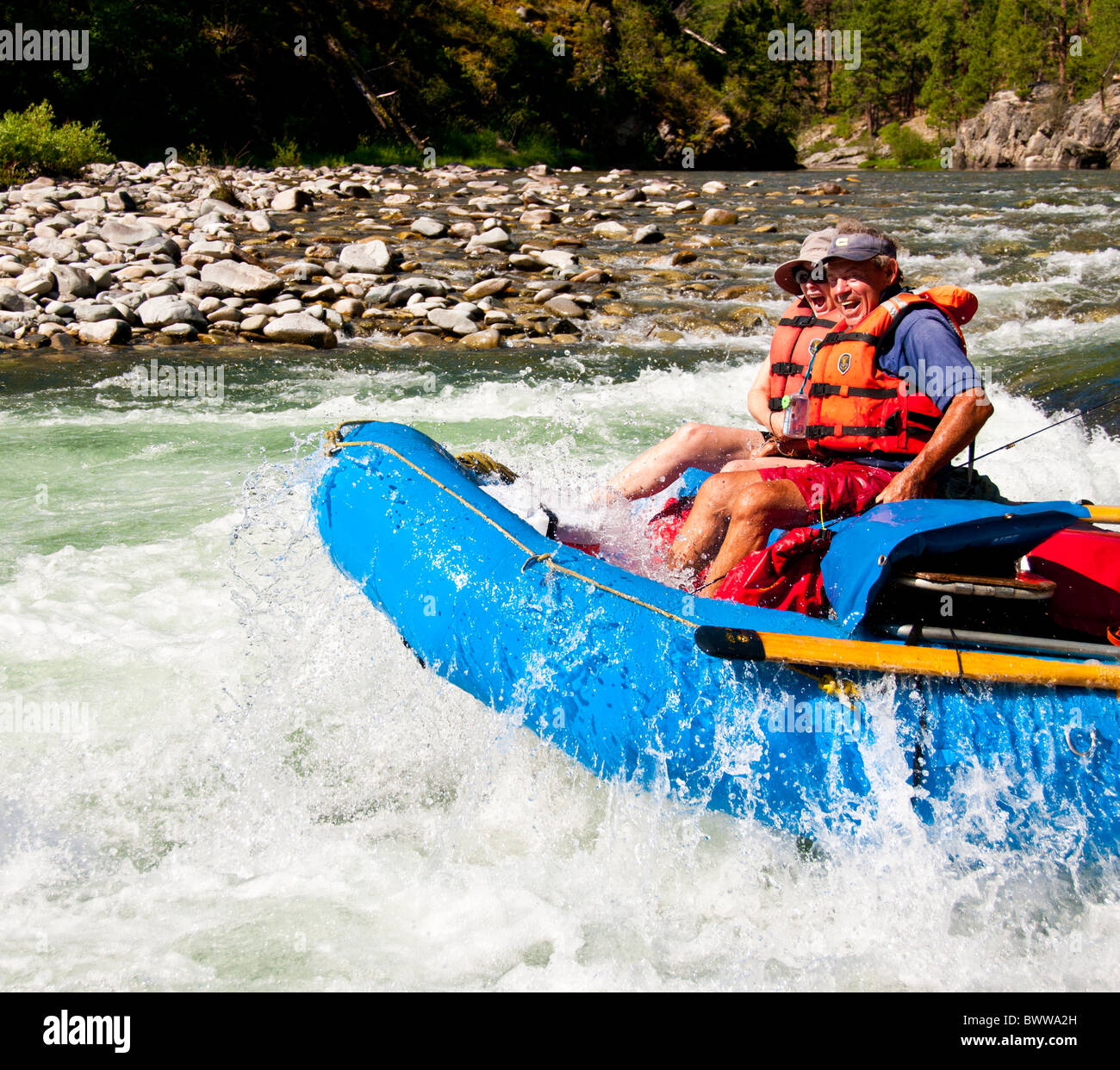 USA, Idaho, Mature Man and woman rafting through churning whitewater ...