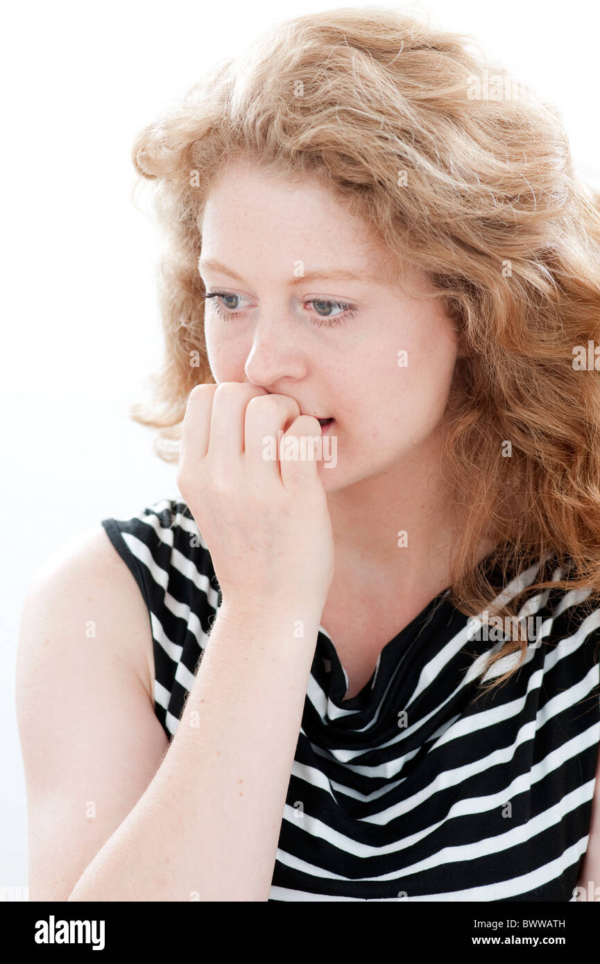 studio portrait of a woman looking worried Stock Photo - Alamy