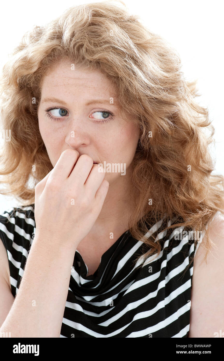 studio portrait of a woman looking worried Stock Photo - Alamy