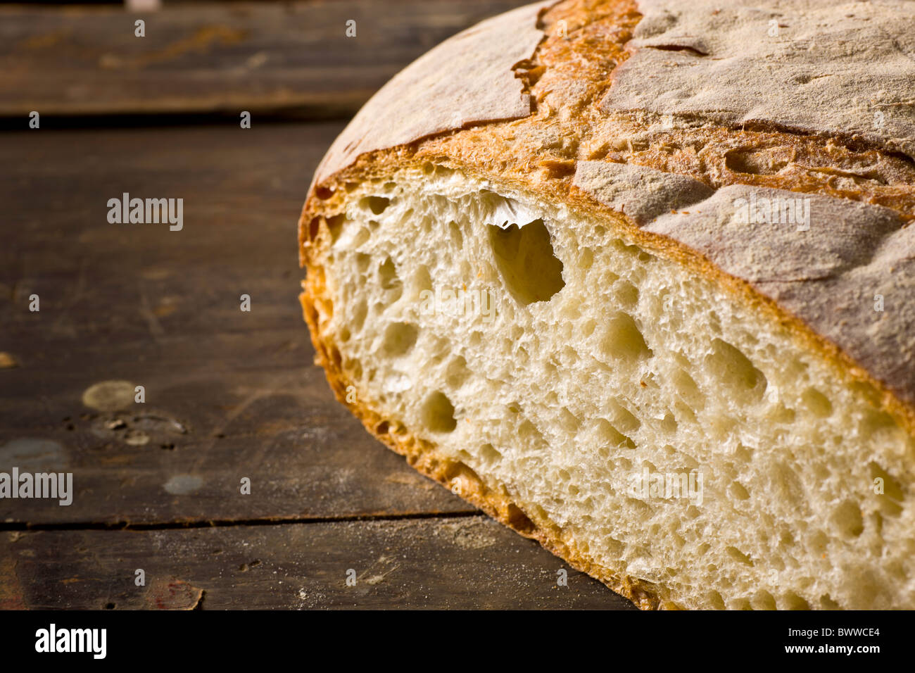 A loaf of artisanal bread on a rustic wood surface Stock Photo - Alamy