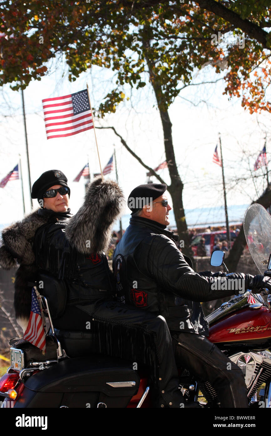A US veteran couple riding a motorcycle in the Veterans Day Parade ...
