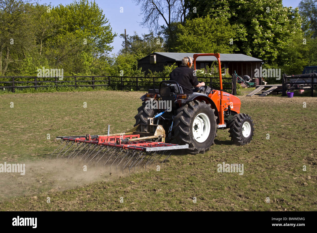 Using a spring tine harrow for paddock maintenance Stock Photo - Alamy
