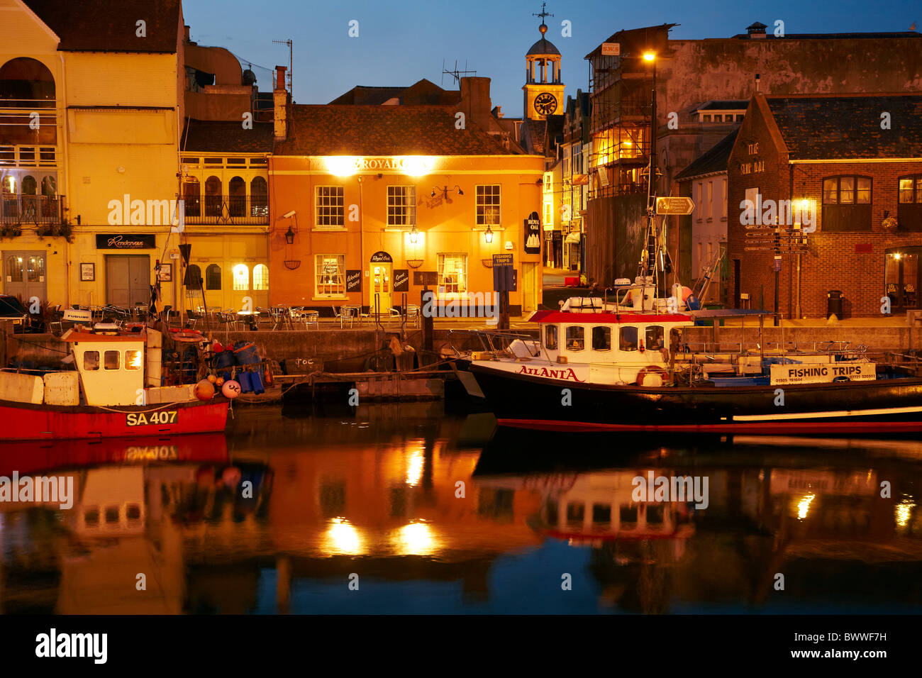 Fishing boats and The Royal Oak, Custom House Quay at dusk, Weymouth ...