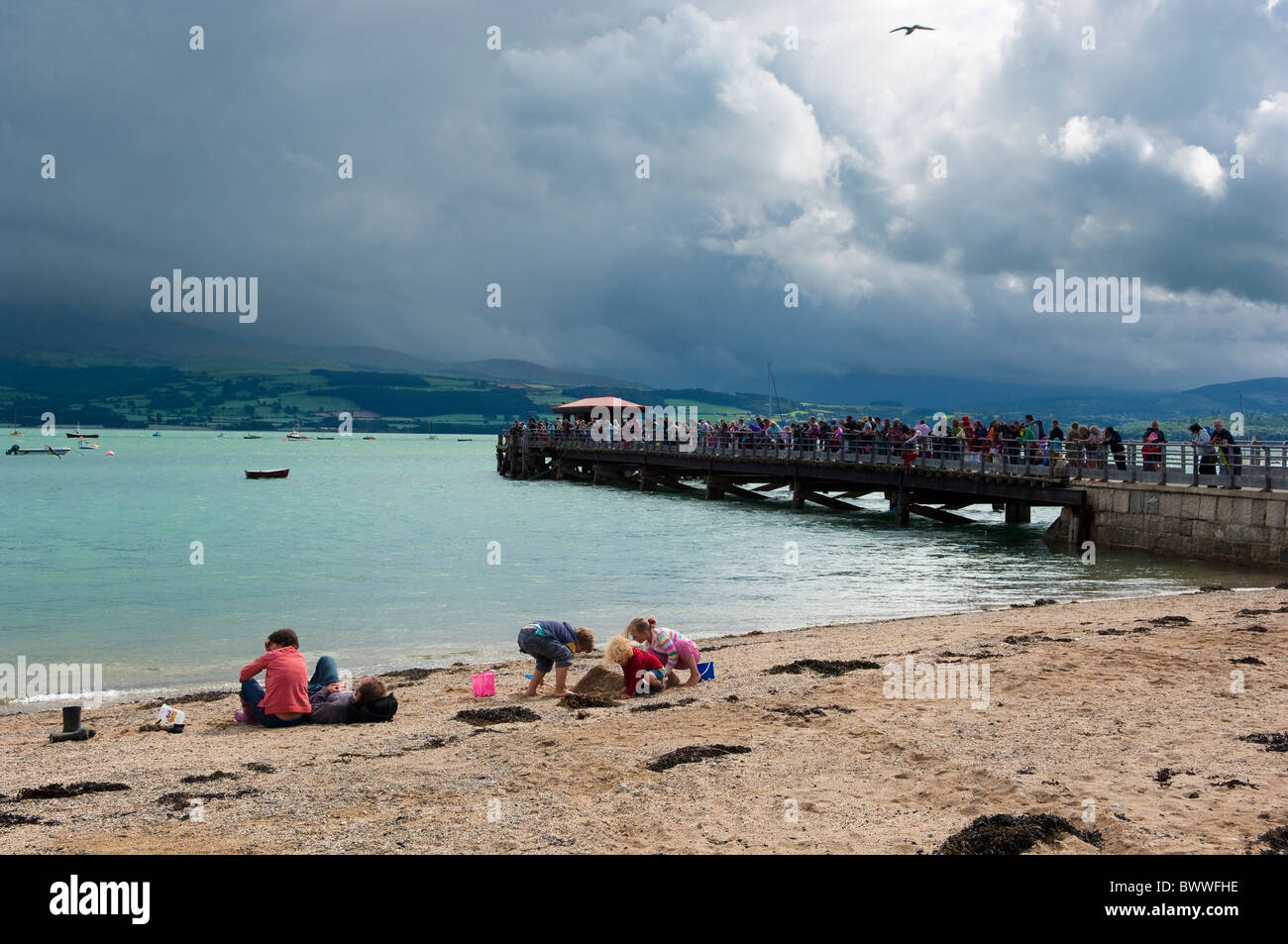 The Beach at Beaumaris, Isle of Anglesey, showing jetty and family ...