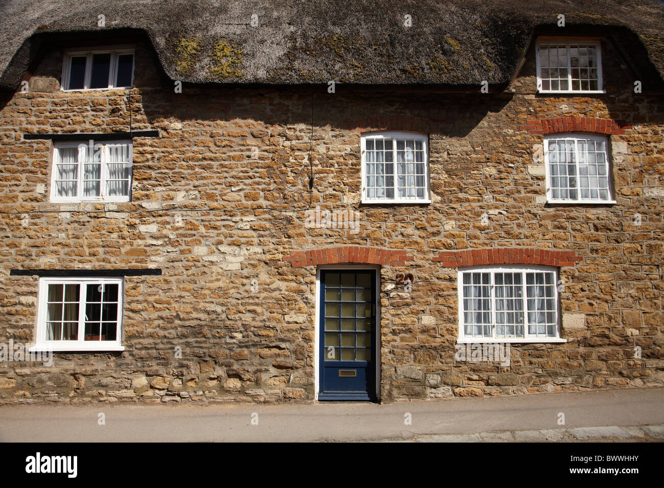 Traditional stone building with thatched roof hi-res stock photography ...