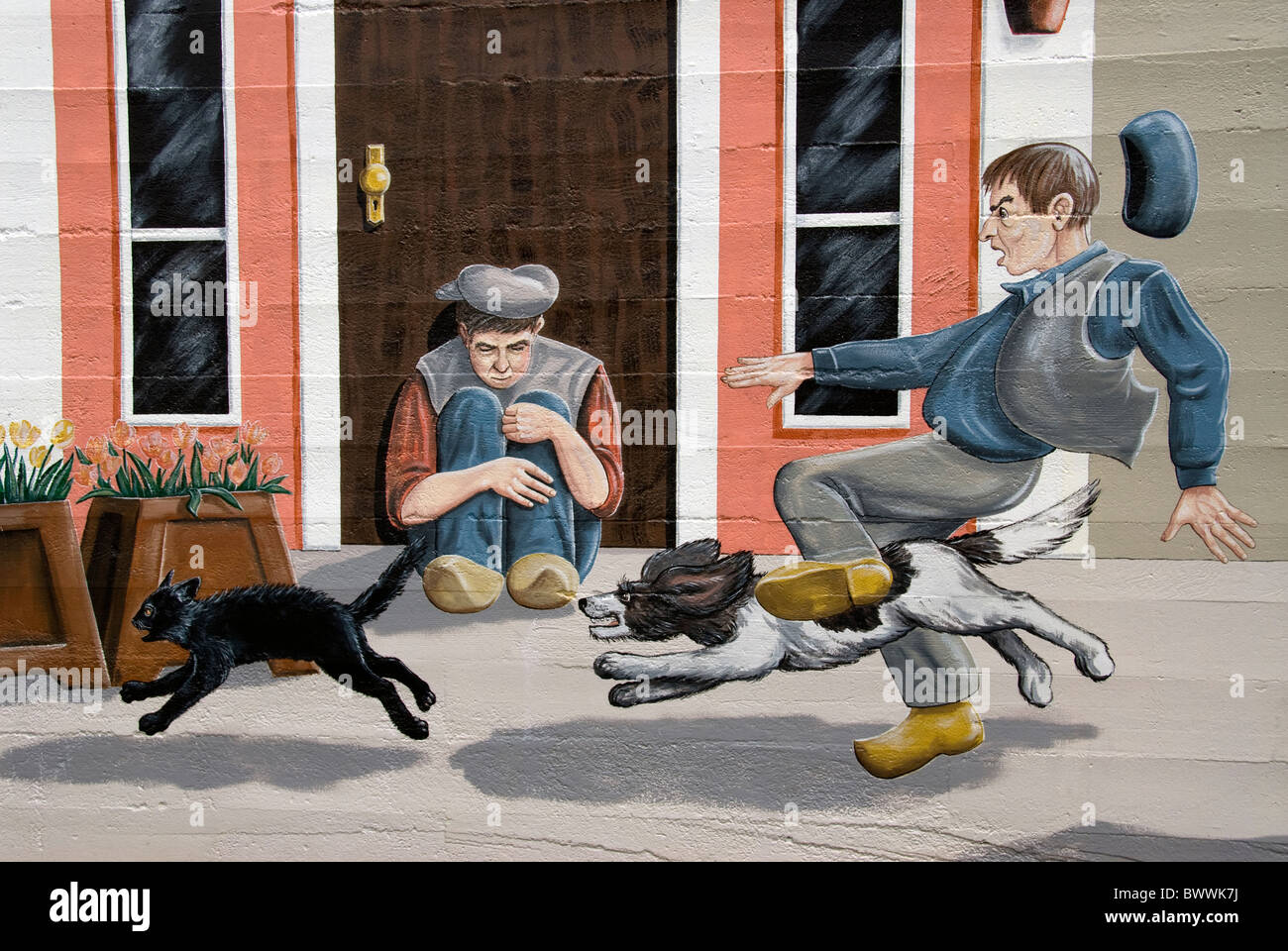 Mural of cat chasing a dog with two men - was released by the artist ...