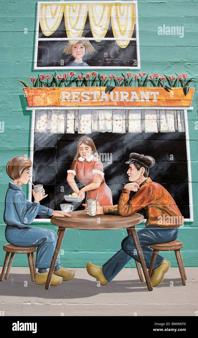 Mural of a couple eating and drinking outside a restaurant. This image ...