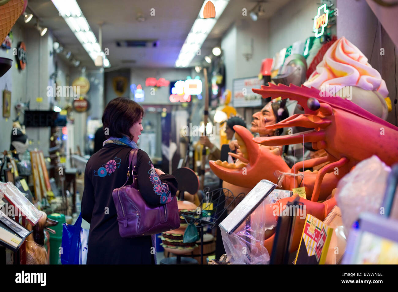 Customers look through a store selling menu boards and signs for ...