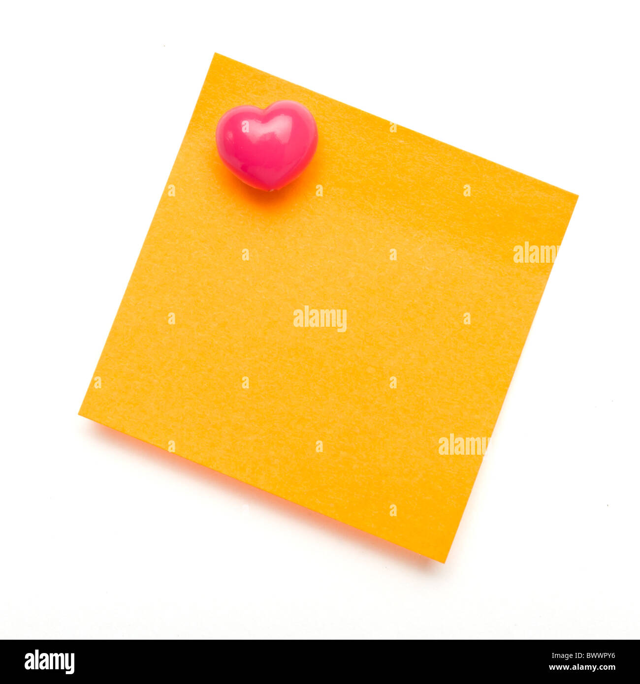 Orange self adhesive post it note with heart shape push pin on white ...
