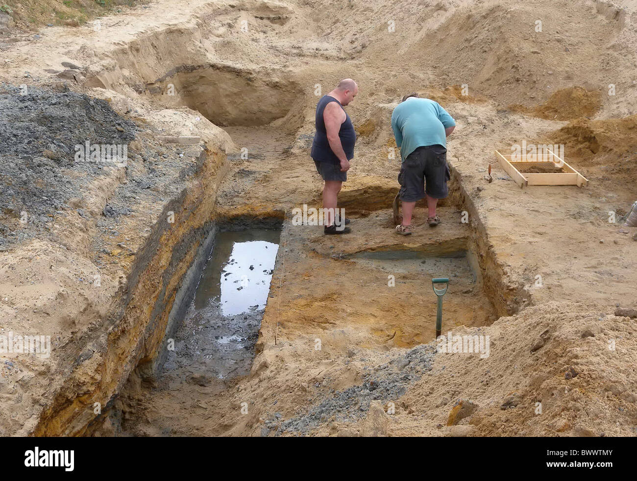 Happisburgh archaeological dig, people digging in trench on beach, at ...