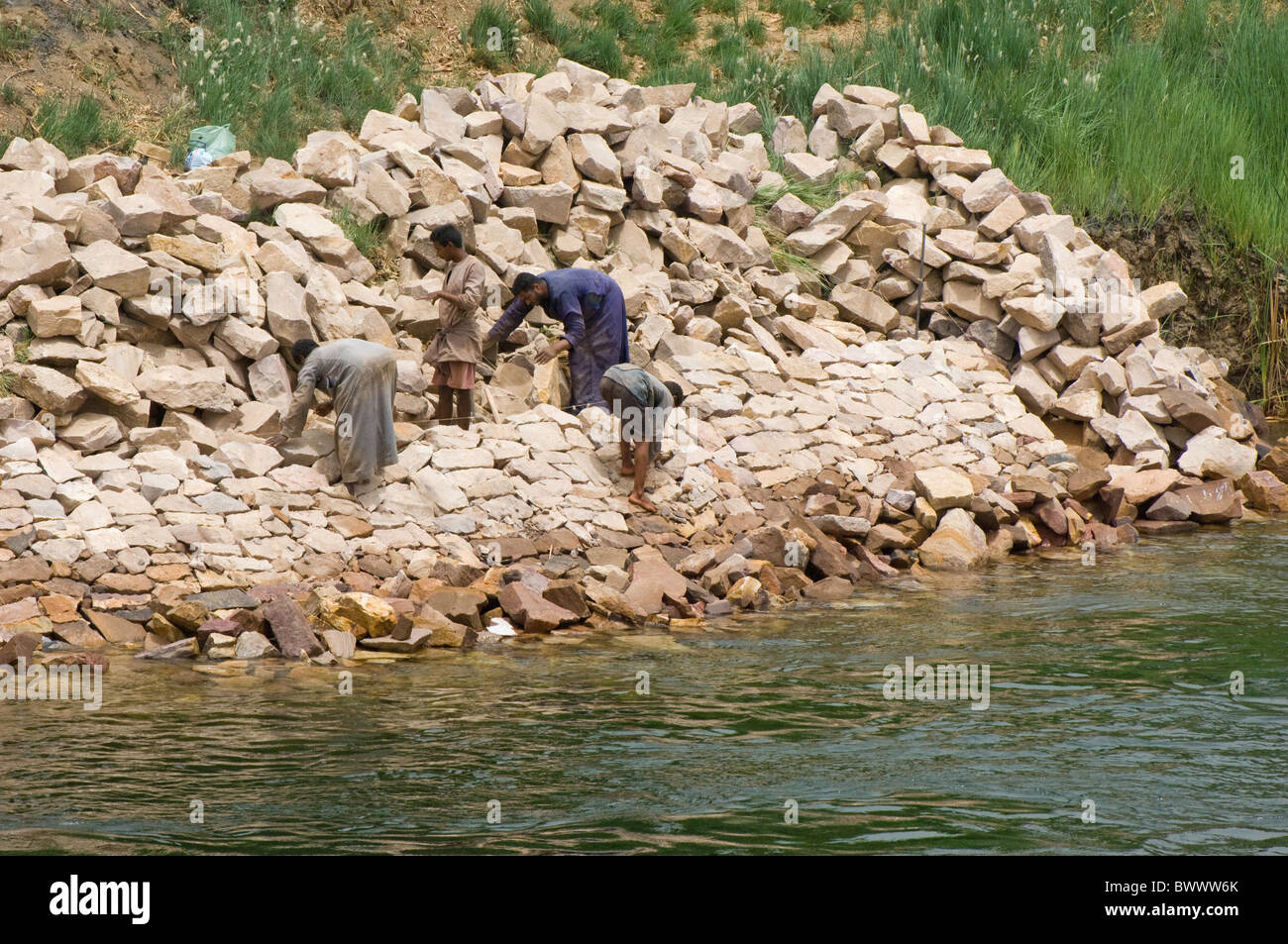 Riverbank erosion people building new limestone Stock Photo - Alamy