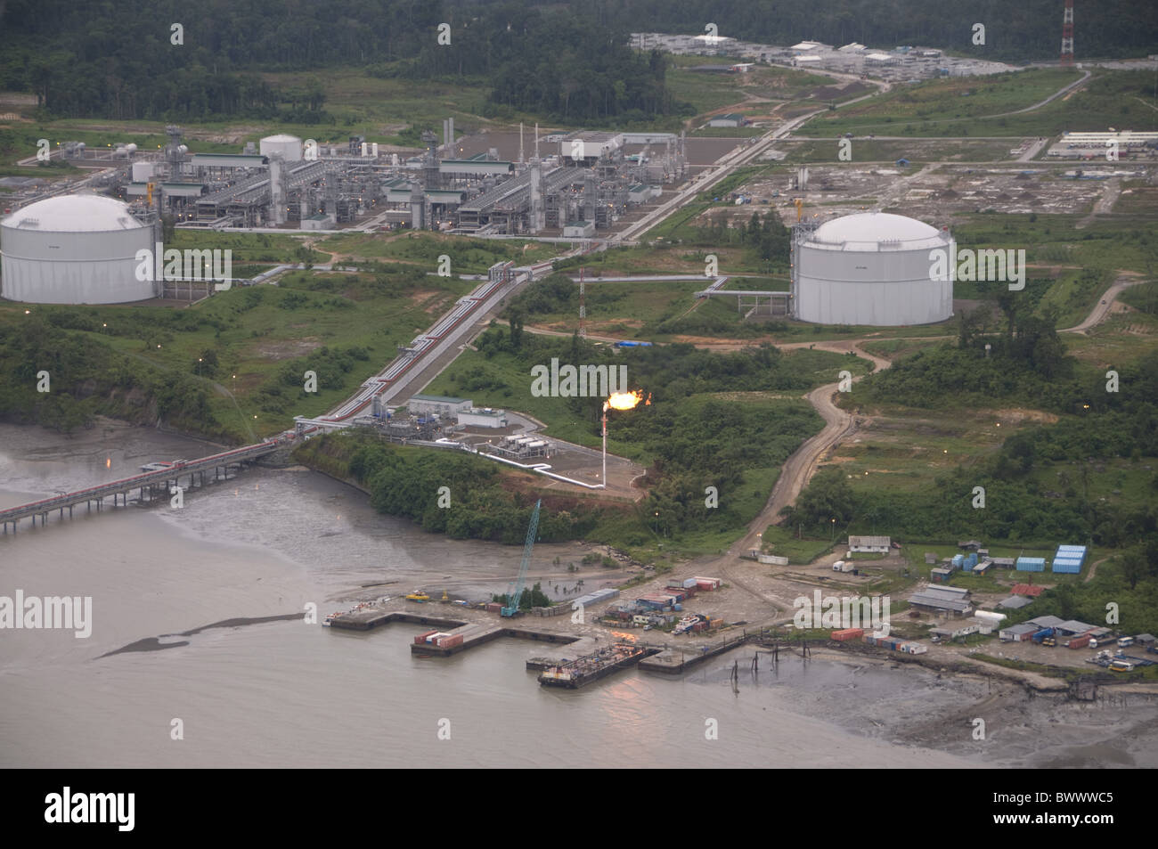 Storage tank, jetty and flare in deforested area, Tangguh LNG ...