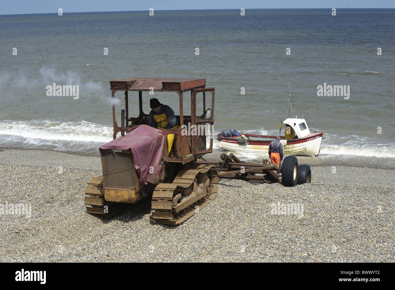 Tractor landing fishing boat beach Weybourne Stock Photo - Alamy