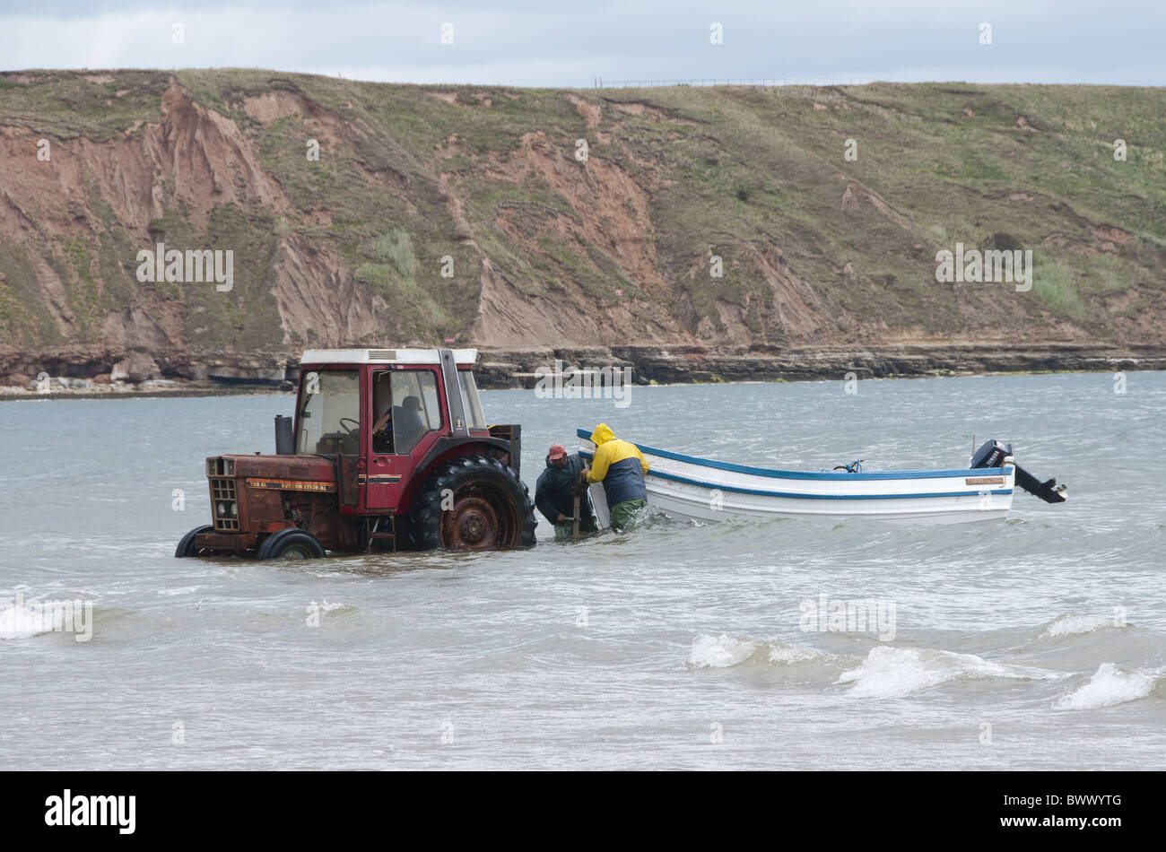 Tractor landing fishing boat Filey North Stock Photo - Alamy