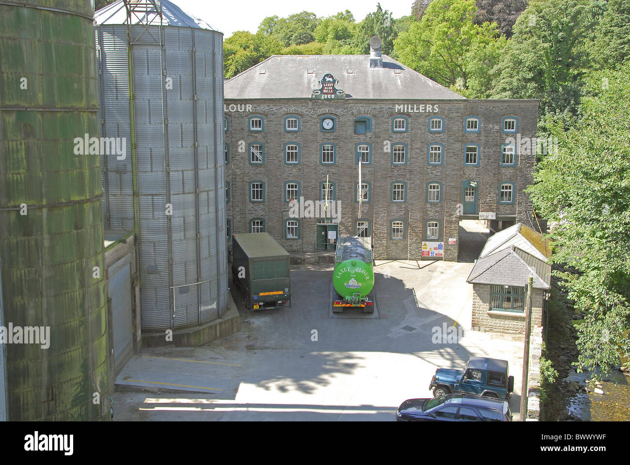 Flour mill buildings silos lorries Laxey Glen Stock Photo - Alamy