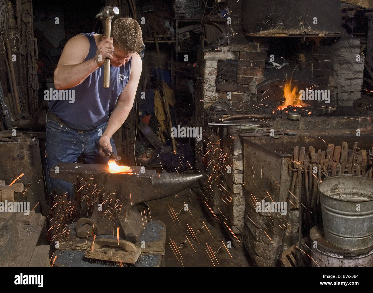 Blacksmith making horseshoes workshop hammering Stock Photo - Alamy