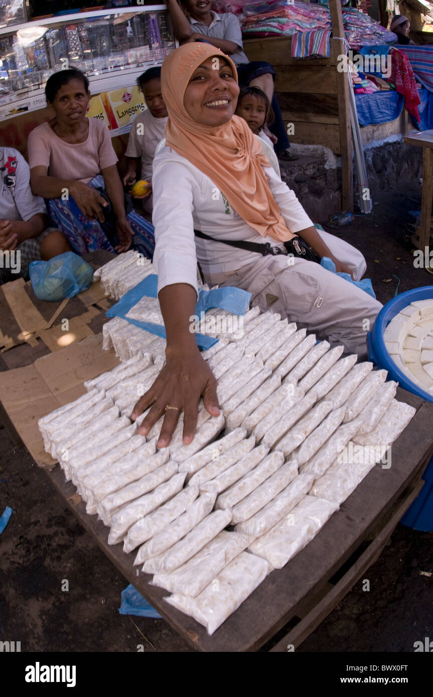 Woman selling soya bean products (tempe and tofu) at market, Kalabahi ...
