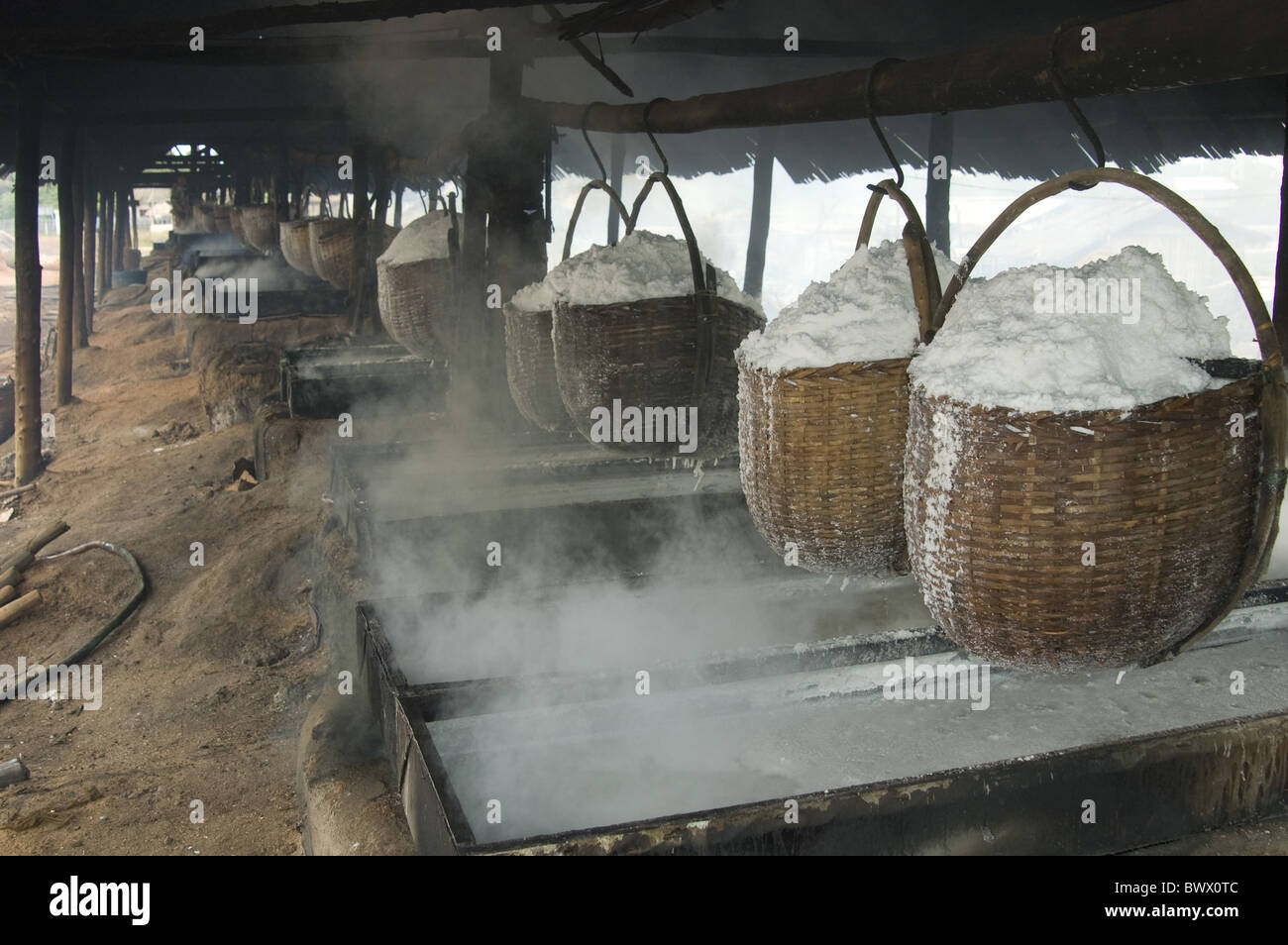 Salt production salt baskets over trays boiling Stock Photo - Alamy