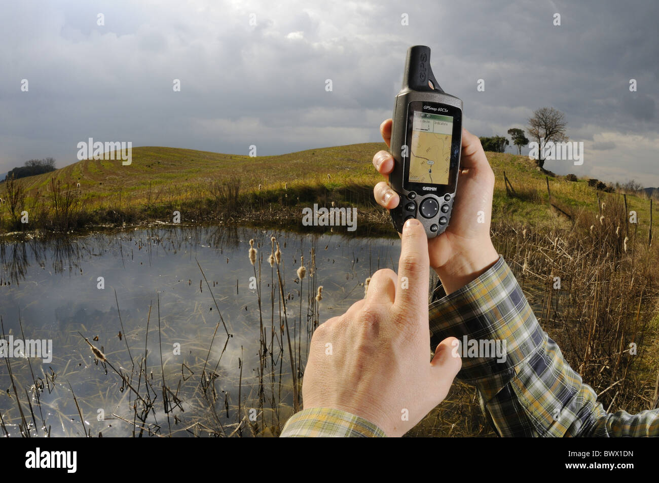 GPS mapping person holding device edge freshwater Stock Photo - Alamy