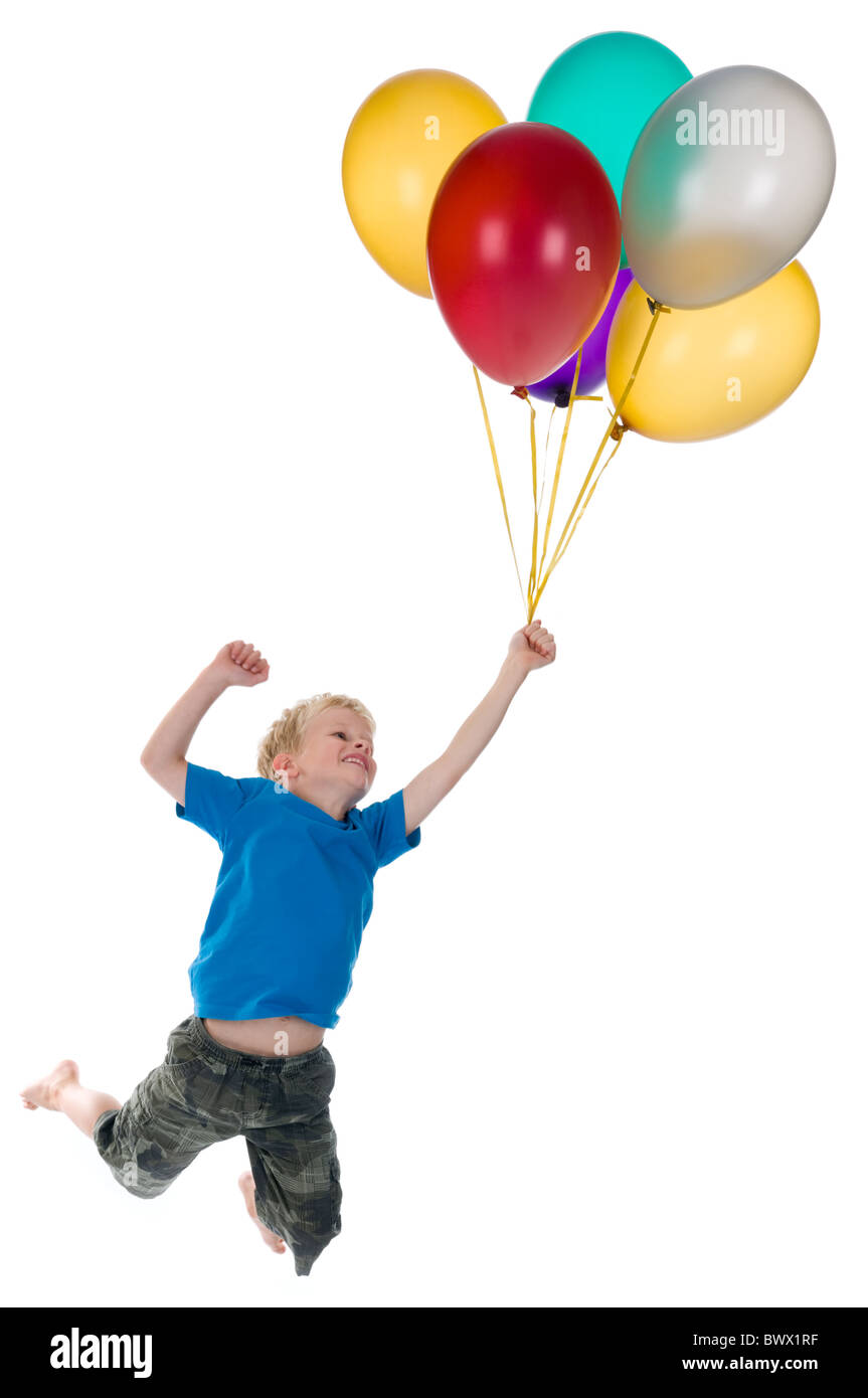 Little boy flying behind a bunch of balloons, isolated on a white ...